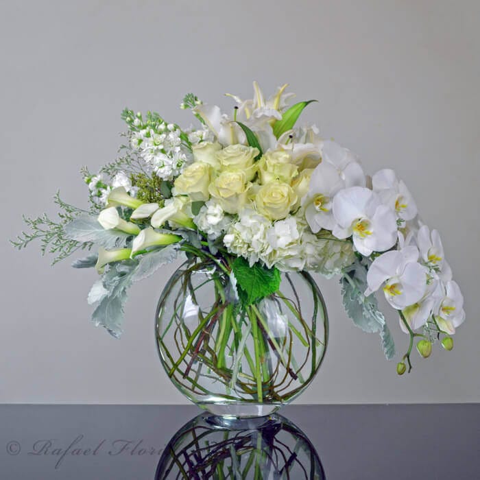 Contemporary flower design of white roses, orchids, hydrangeas, roses